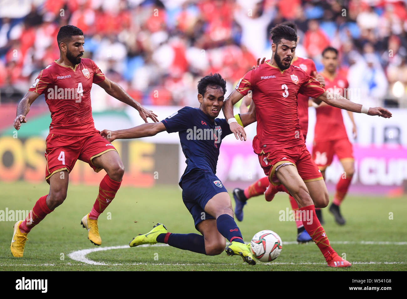 Teerasil Dangda, center, of Thailand dribbles against Sayed Dhiya Saeed ...