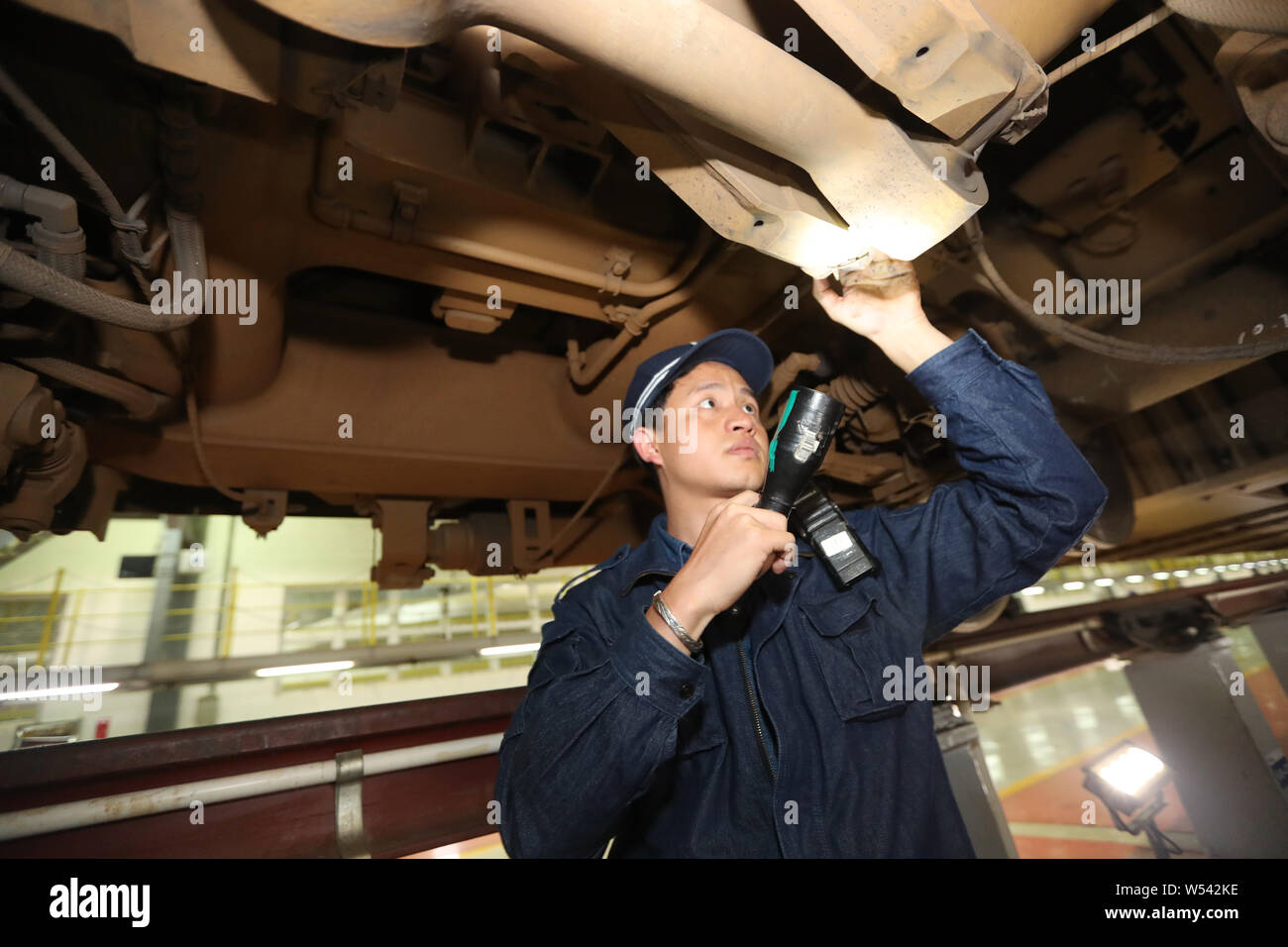 A Chinese mechanic checks a high-speed bullet train during the Spring ...