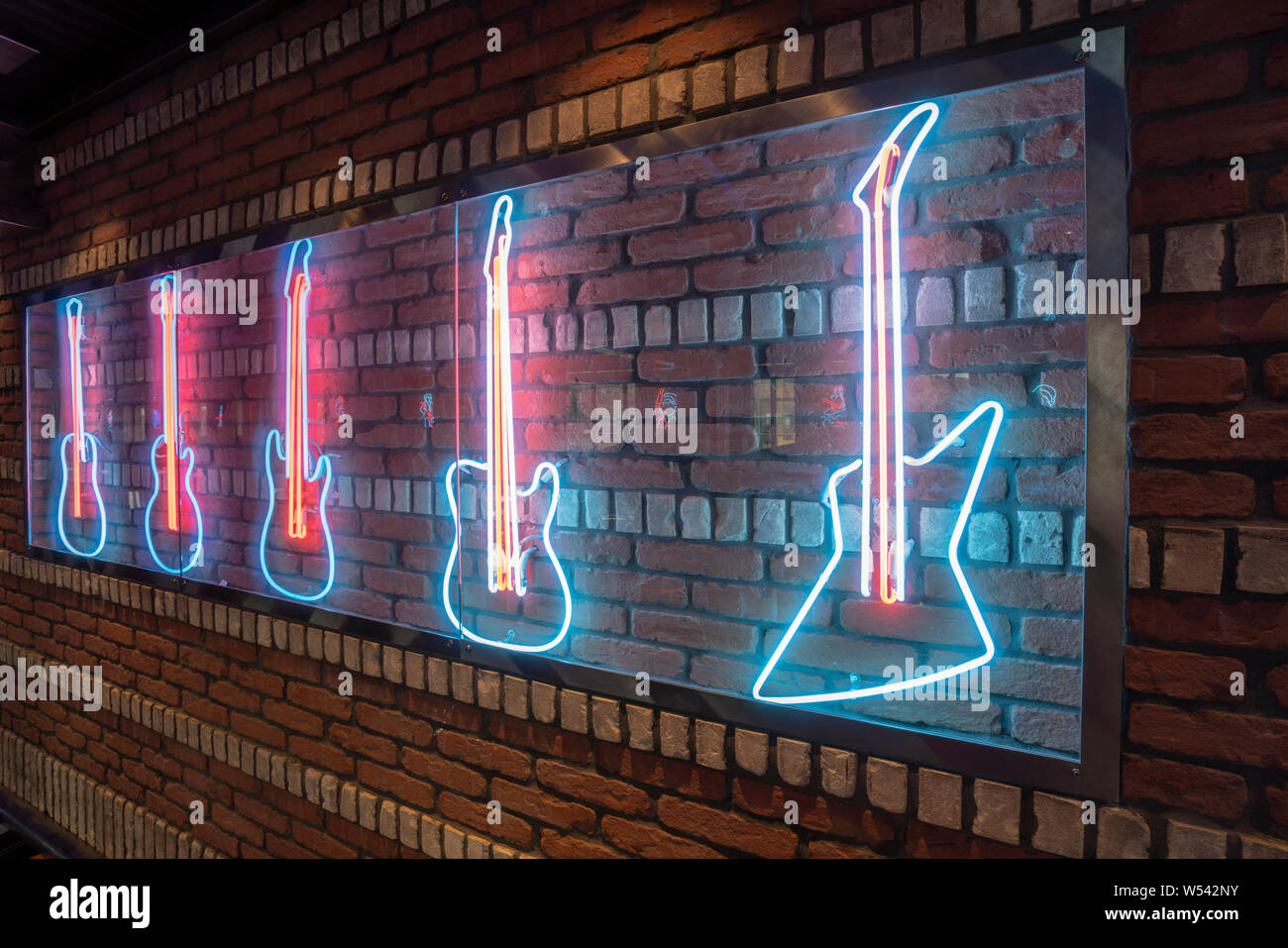 Rock Bar Neon decoration of Guitars on Brick Wall Stock Photo - Alamy
