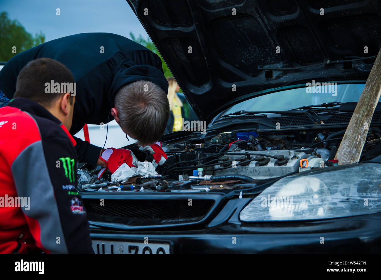 Car mechanics repairing sports car engine Stock Photo - Alamy