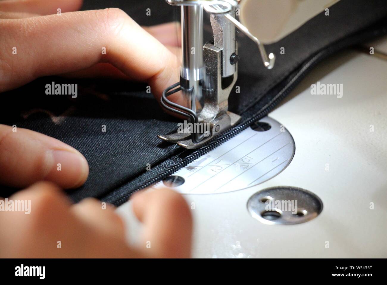 A Chinese worker sews a product made of China's first far infrared ...