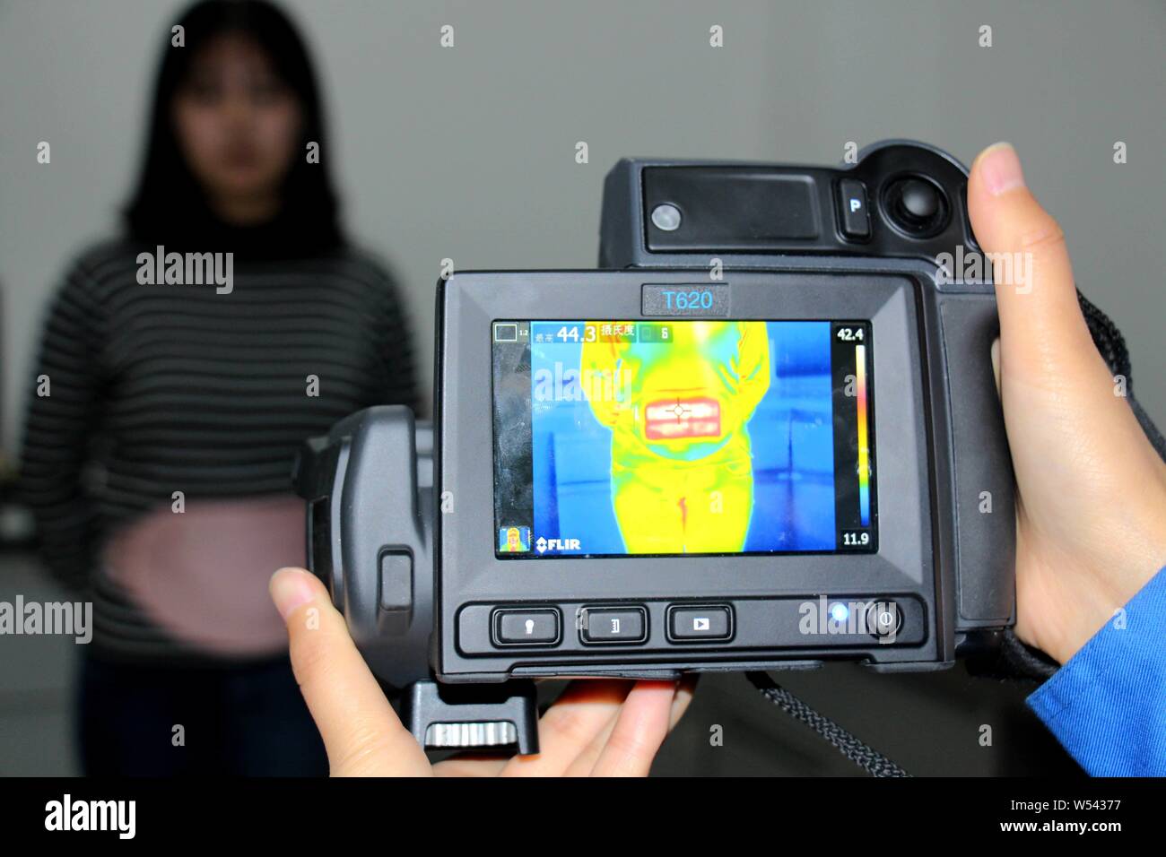 A Chinese worker uses a forward-looking infrared (FLIR) camera to test ...