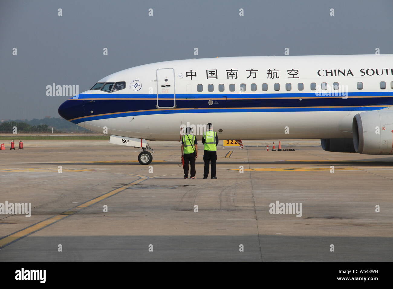 --FILE--Chinese ground crew members direct a jet plane of China ...