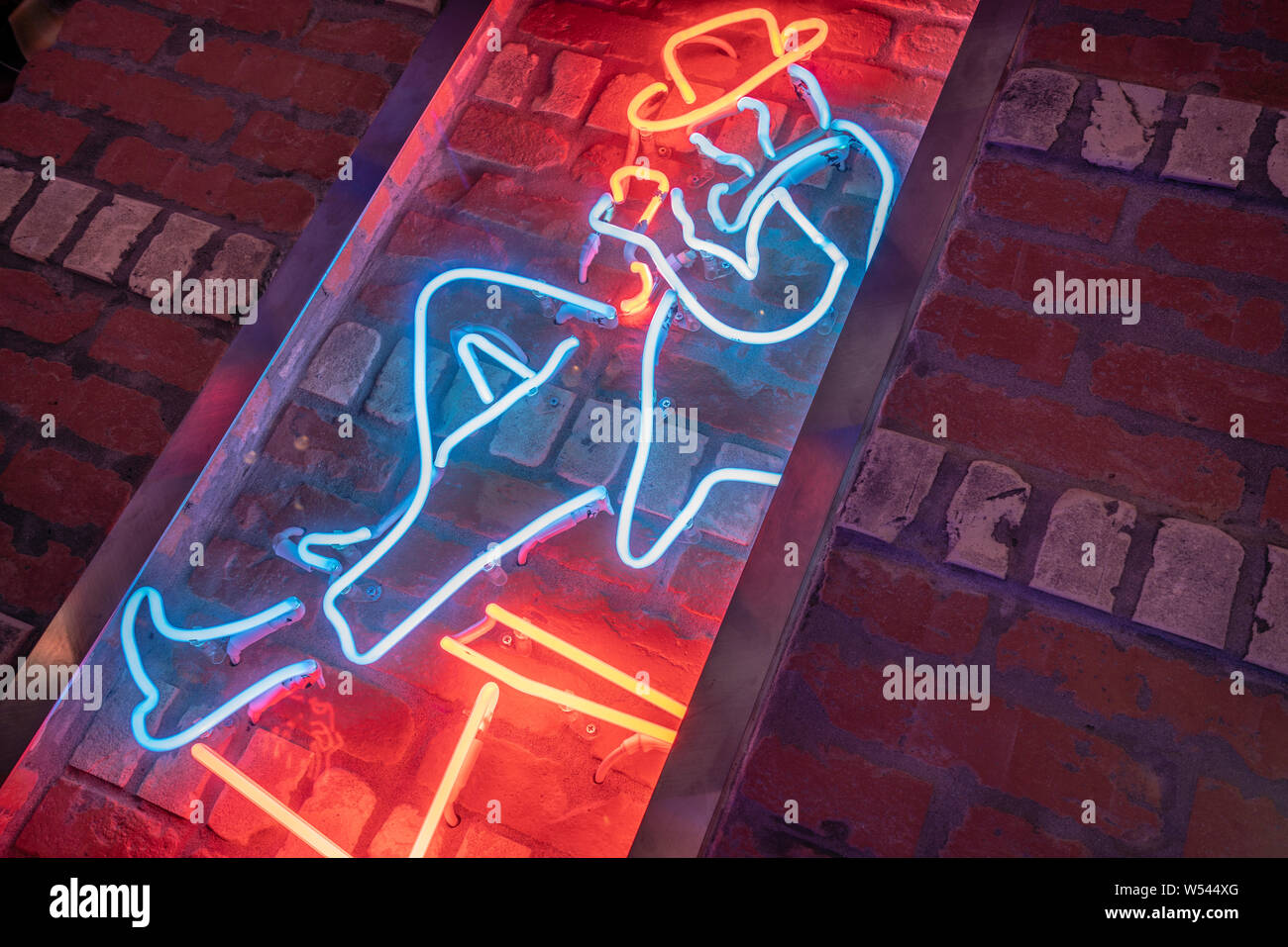 Neon Light in shape of a man in a Rock Bar as decoration Stock Photo ...