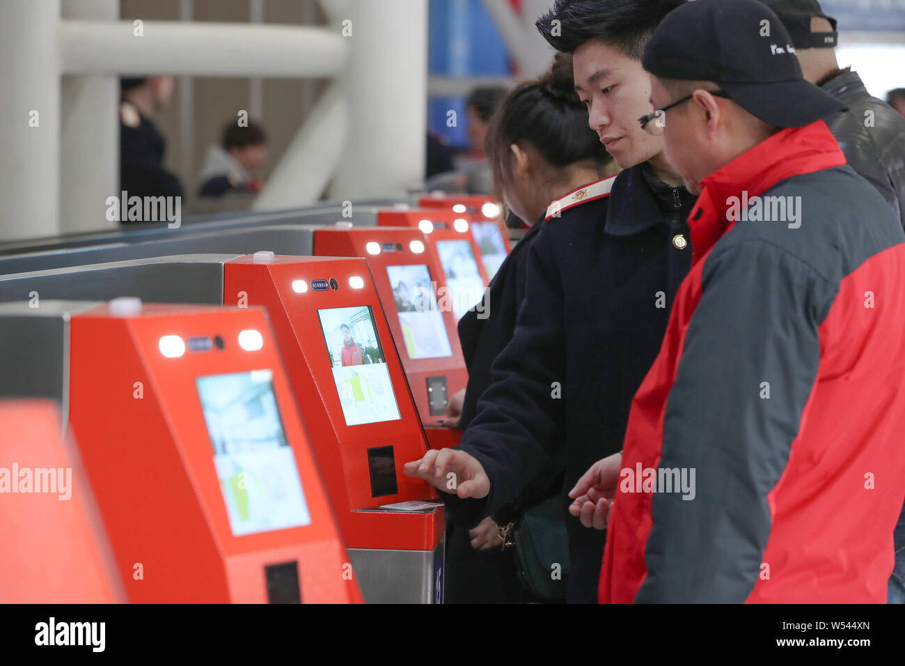 Passengers have their faces scanned by a face recognition system to ...