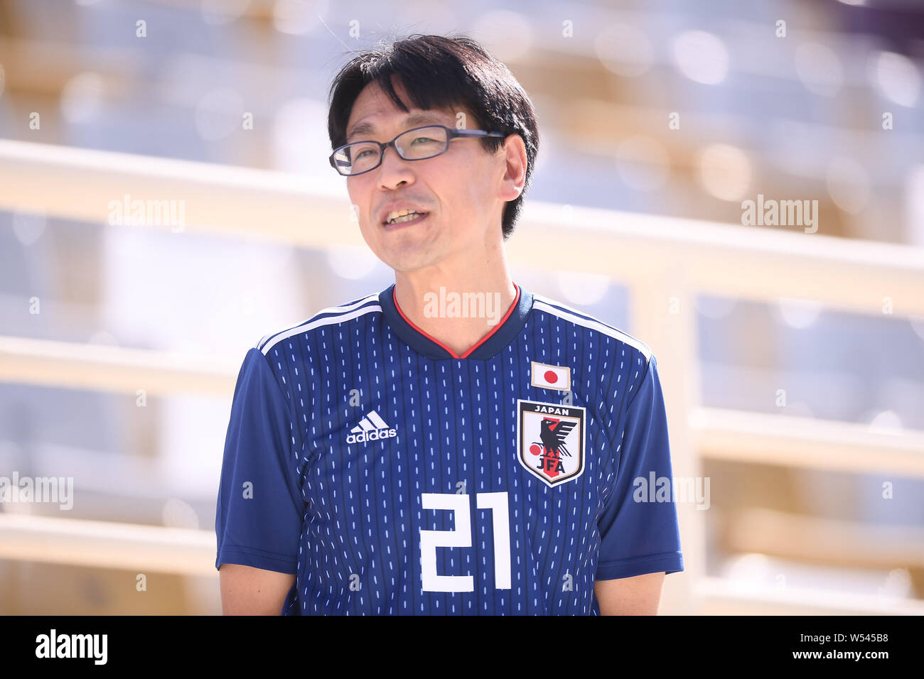 Japanese football fans wave their national flags to show support for ...