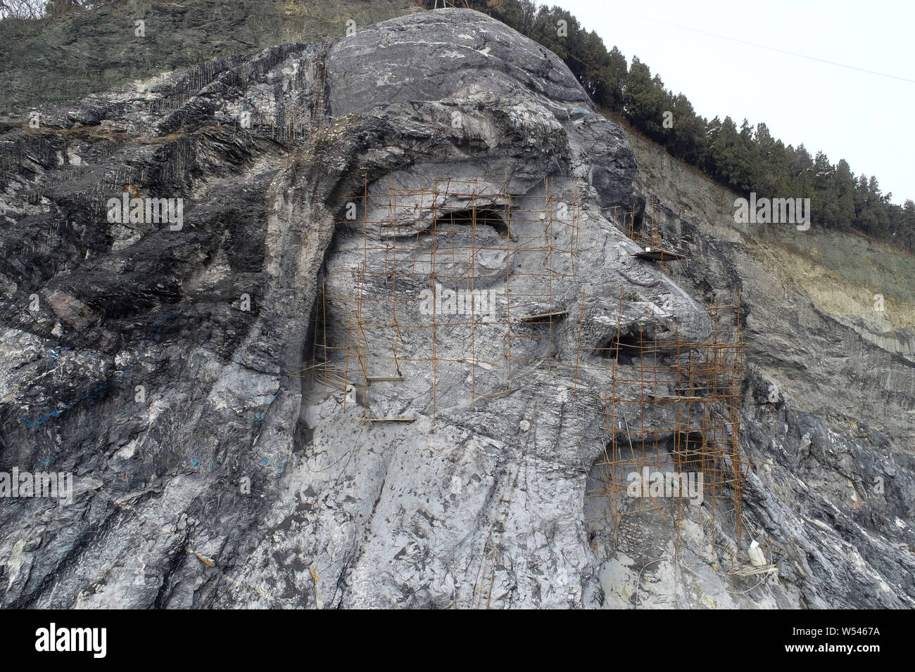 A sculpture of Fuxi, a culture hero in Chinese legends, is being carved ...