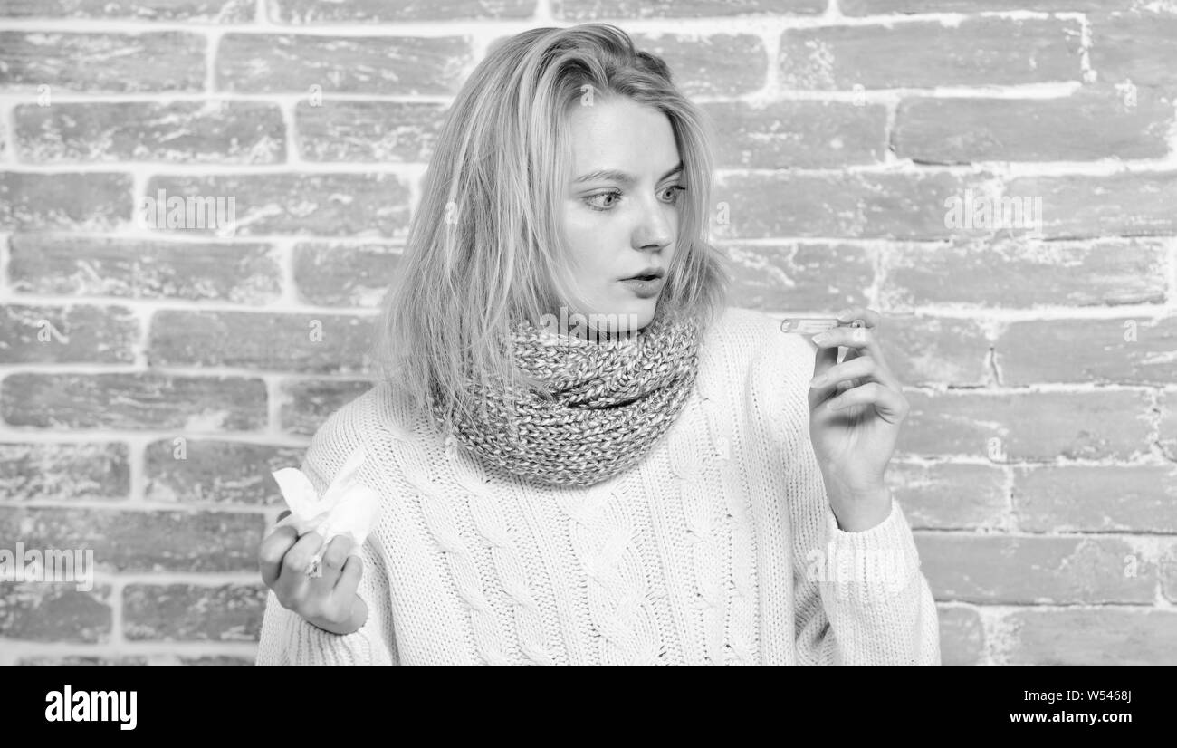 High temperature. Sick woman holding fever thermometer. Cute ill girl ...