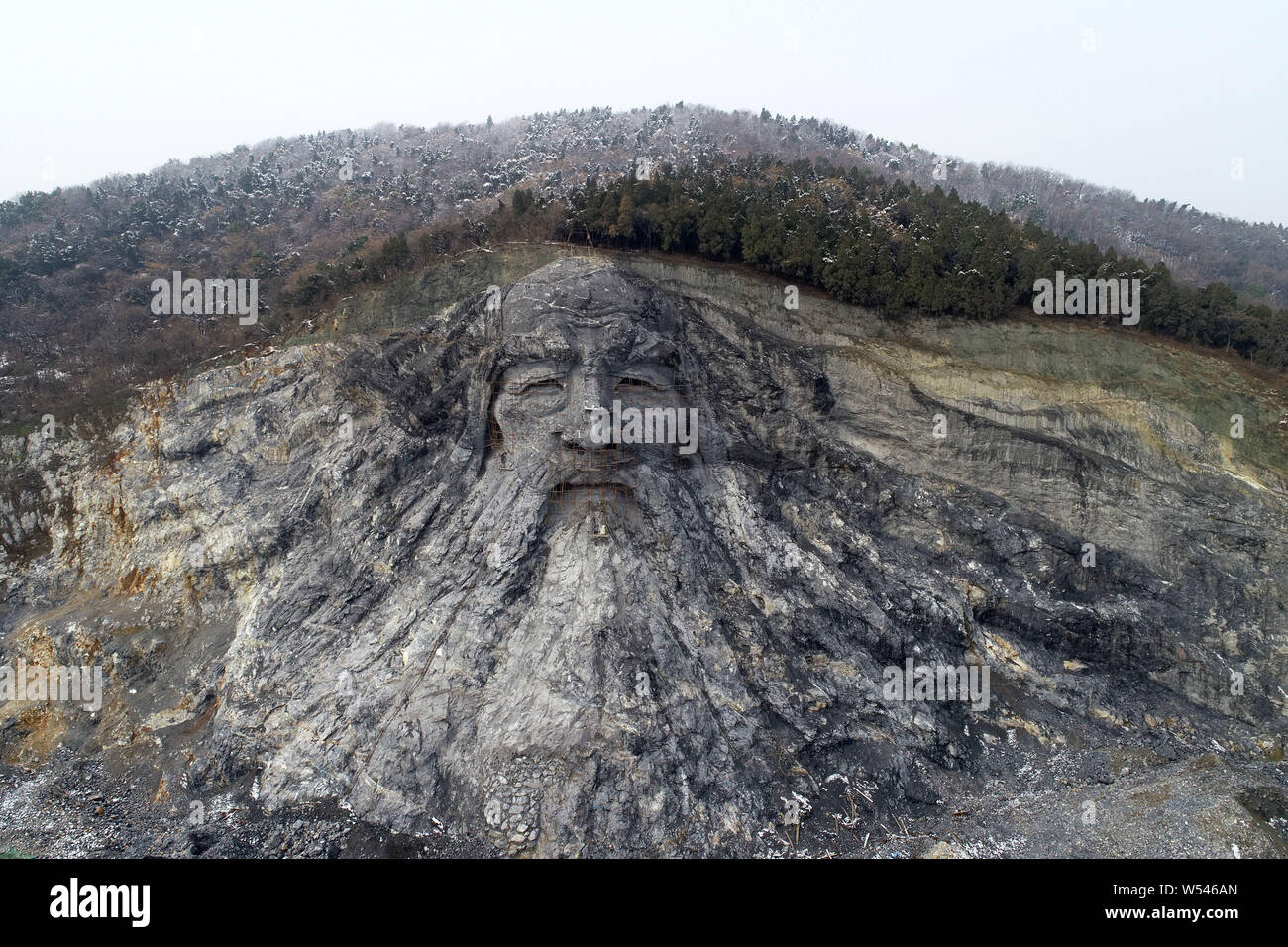 A sculpture of Fuxi, a culture hero in Chinese legends, is being carved ...