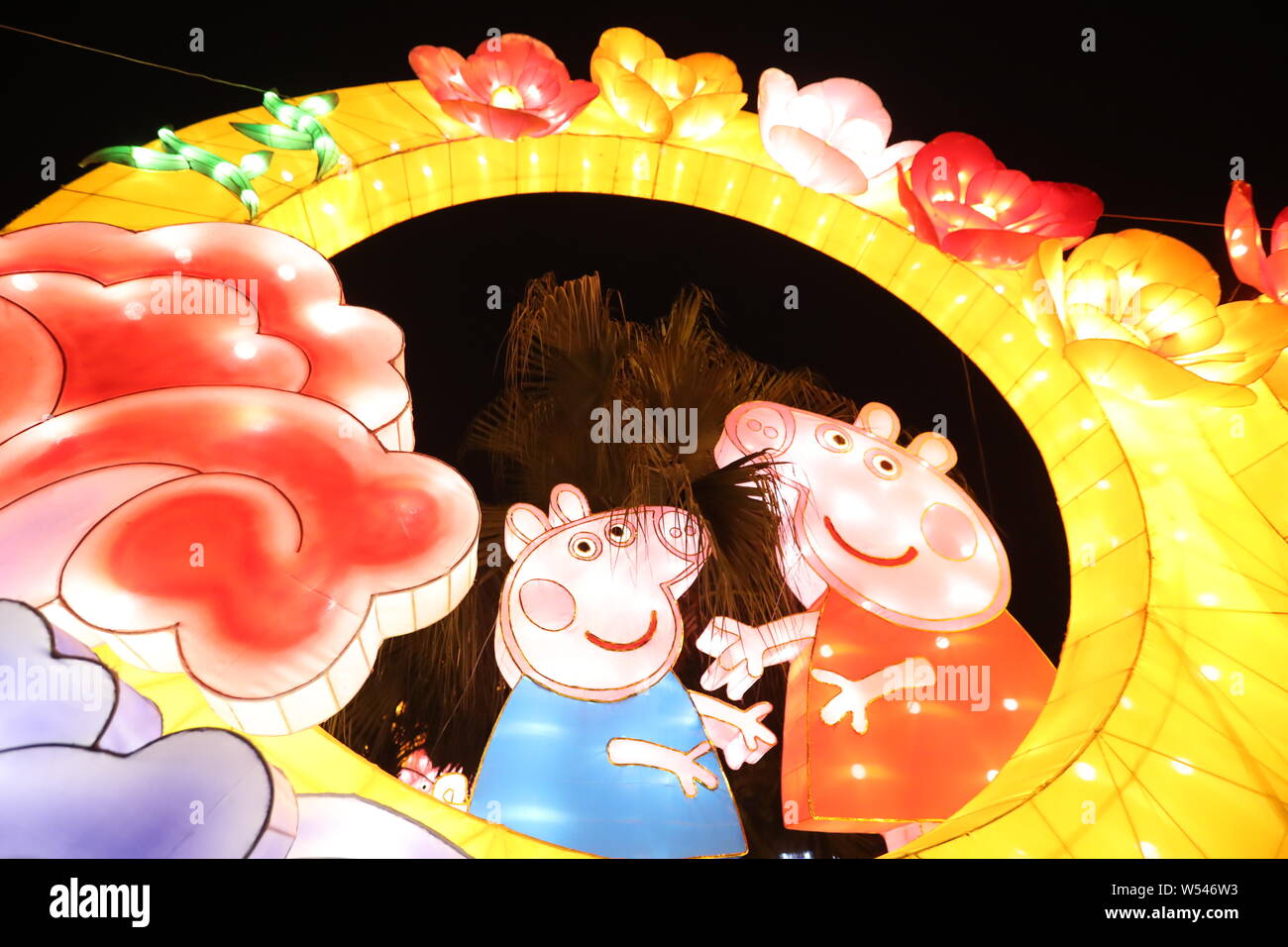 Colorful and illuminated lanterns featuring shaped of Peppa Pig are ...