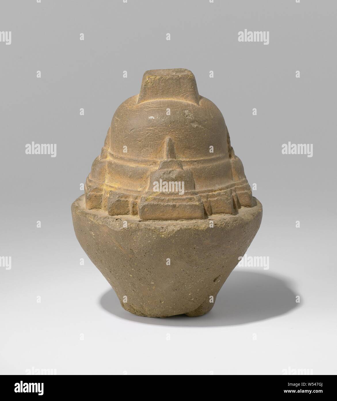 Miniature stupa, lower part roughly shaped, tapered downwards, upper ...