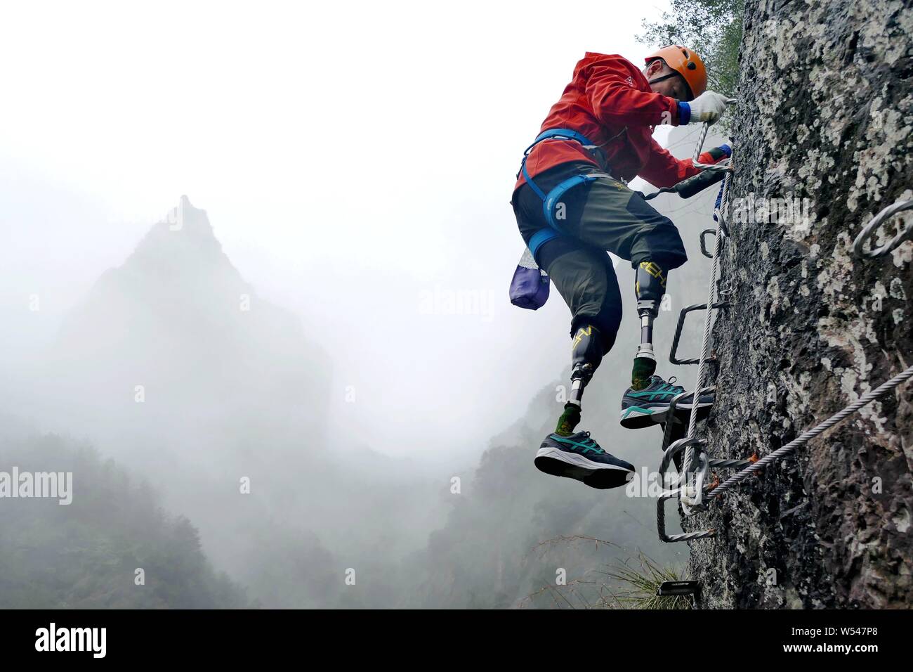 69-year-old double-amputee Chinese climber Xia Boyu tries rock climbing at a cliff mountain in ...