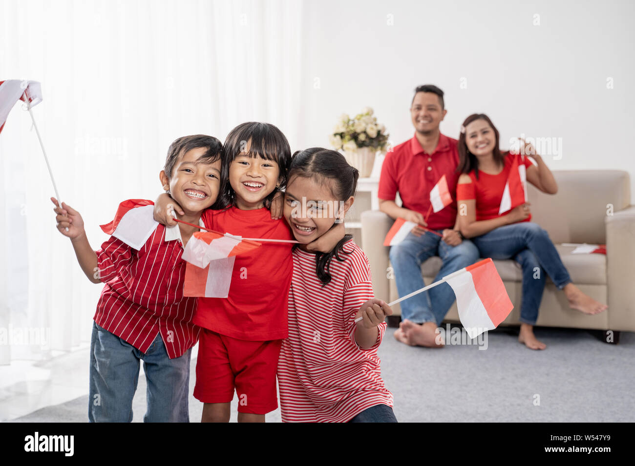indonesian family holding indonesia flag over white background Stock ...