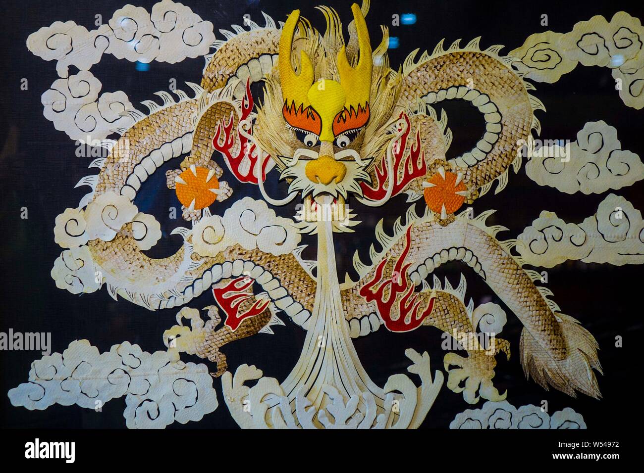 A painting made of fish skins by the Hezhen People is on display at a ...