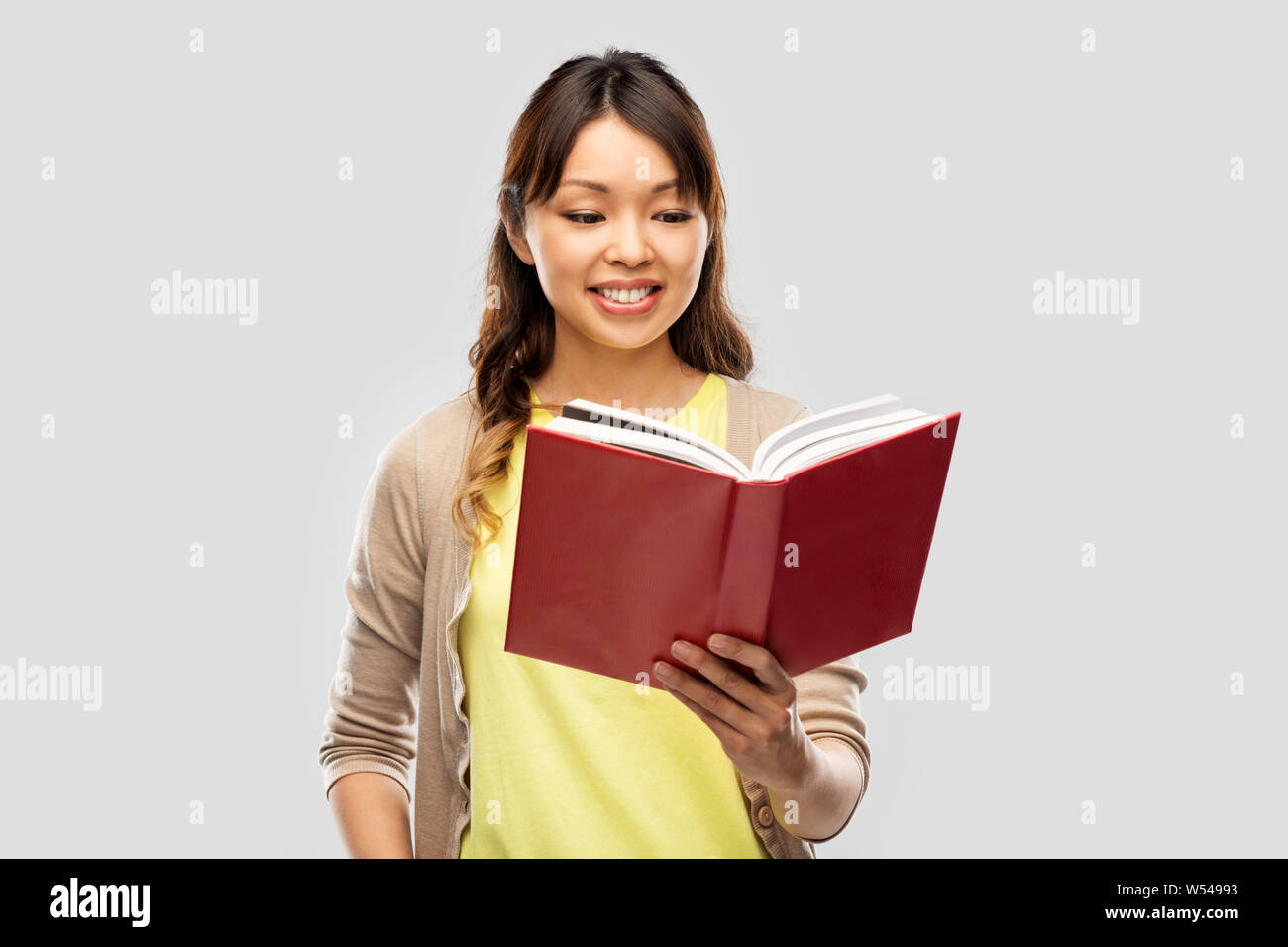 happy asian woman reading book Stock Photo - Alamy