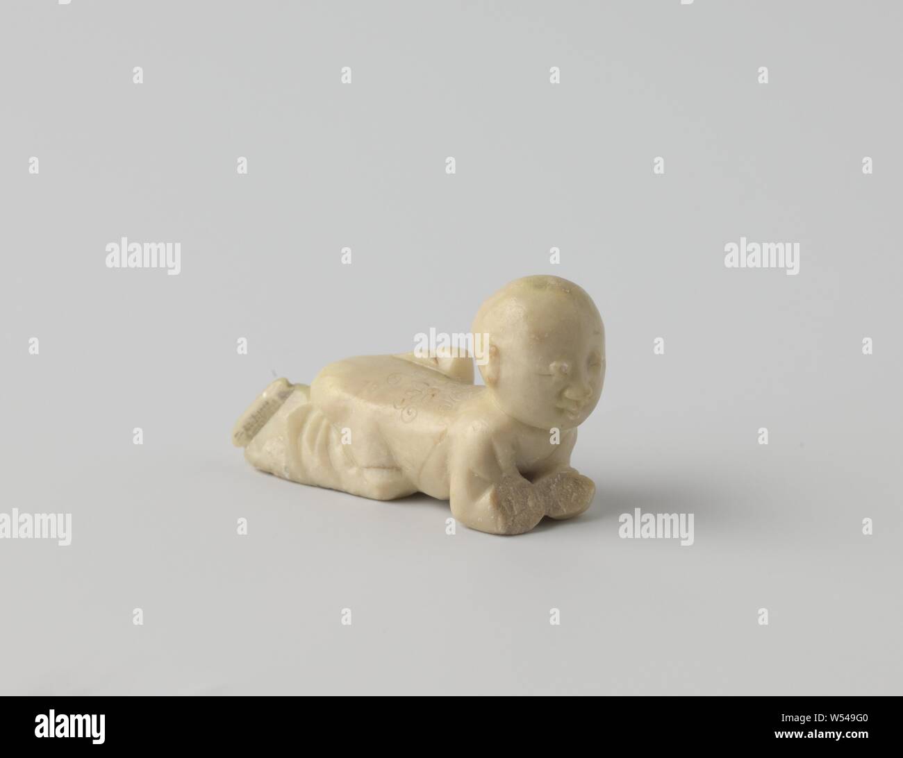 A crawling child figure of soapstone, A crawling child figure of ivory ...