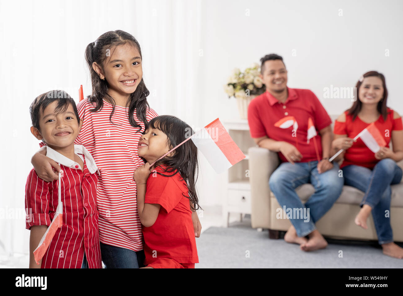indonesian family holding indonesia flag over white background Stock ...