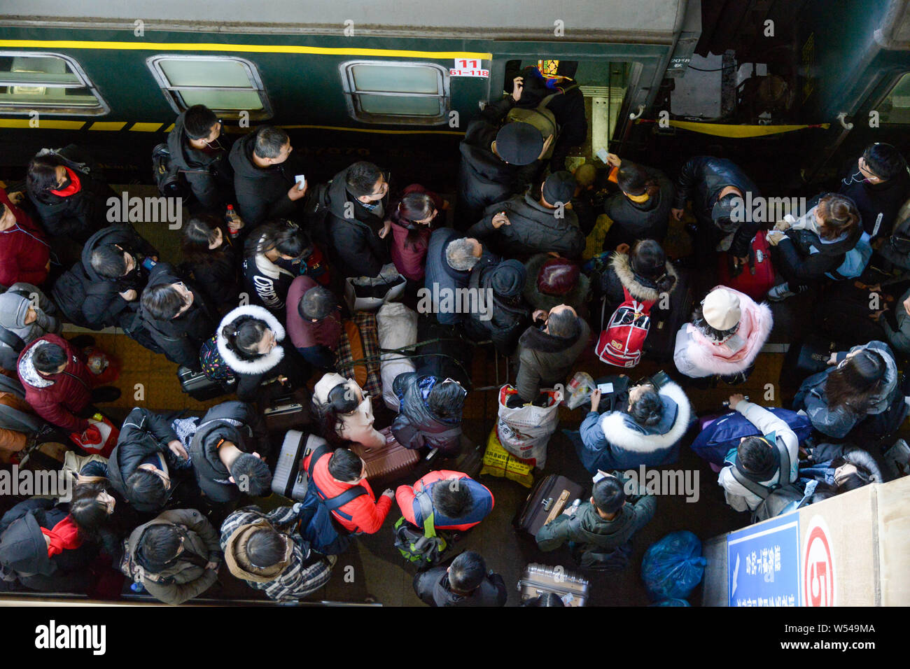 Chinese passengers board a train to go back home for the Chinese Lunar ...