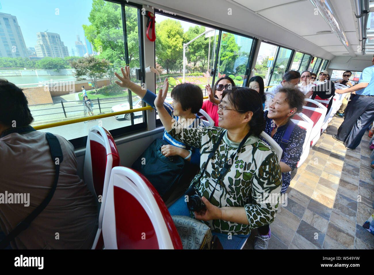 Elderly Chinese people take a sightseeing bus to travel around tourist ...
