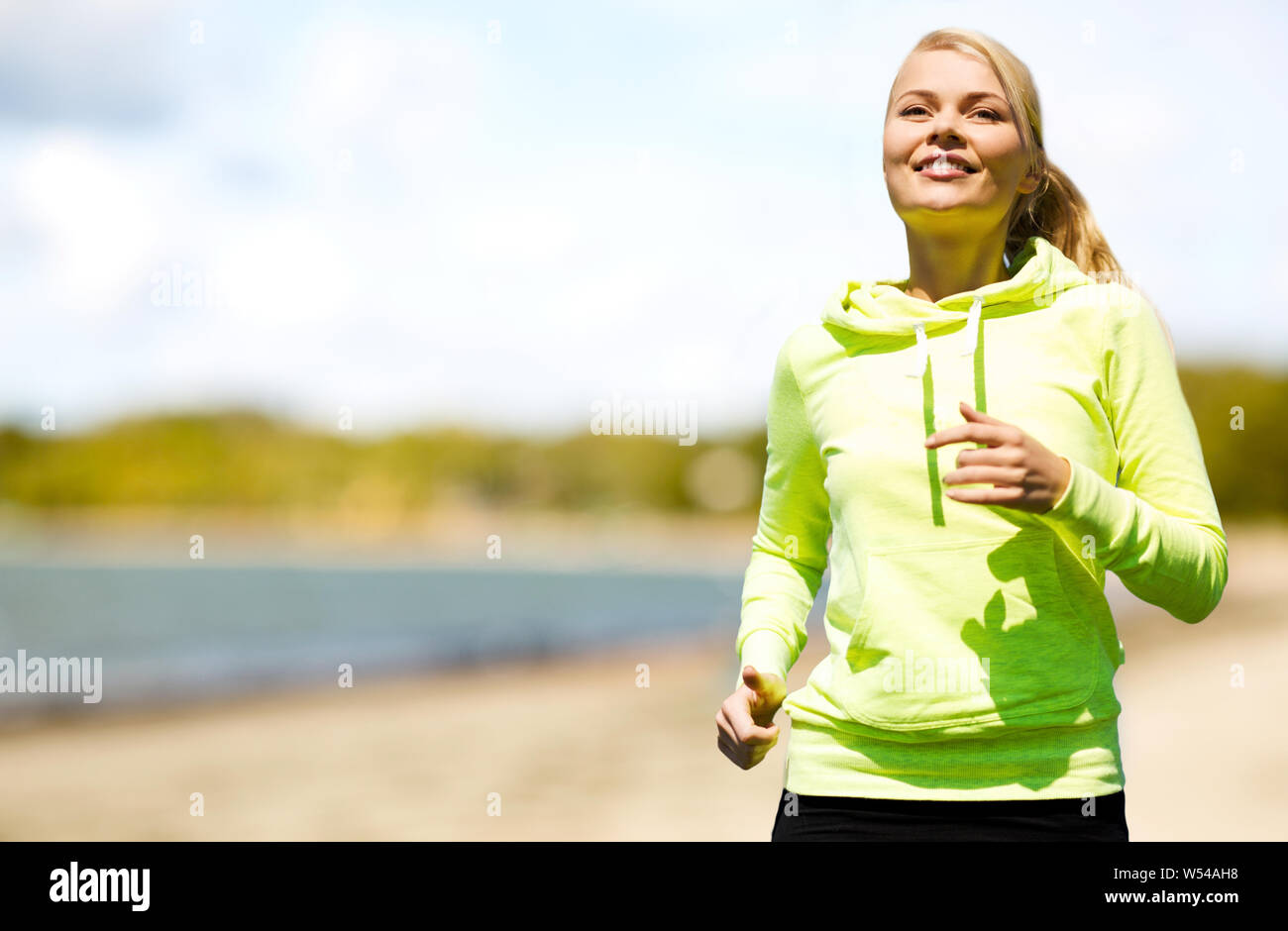 Woman running at beach hi-res stock photography and images - Alamy