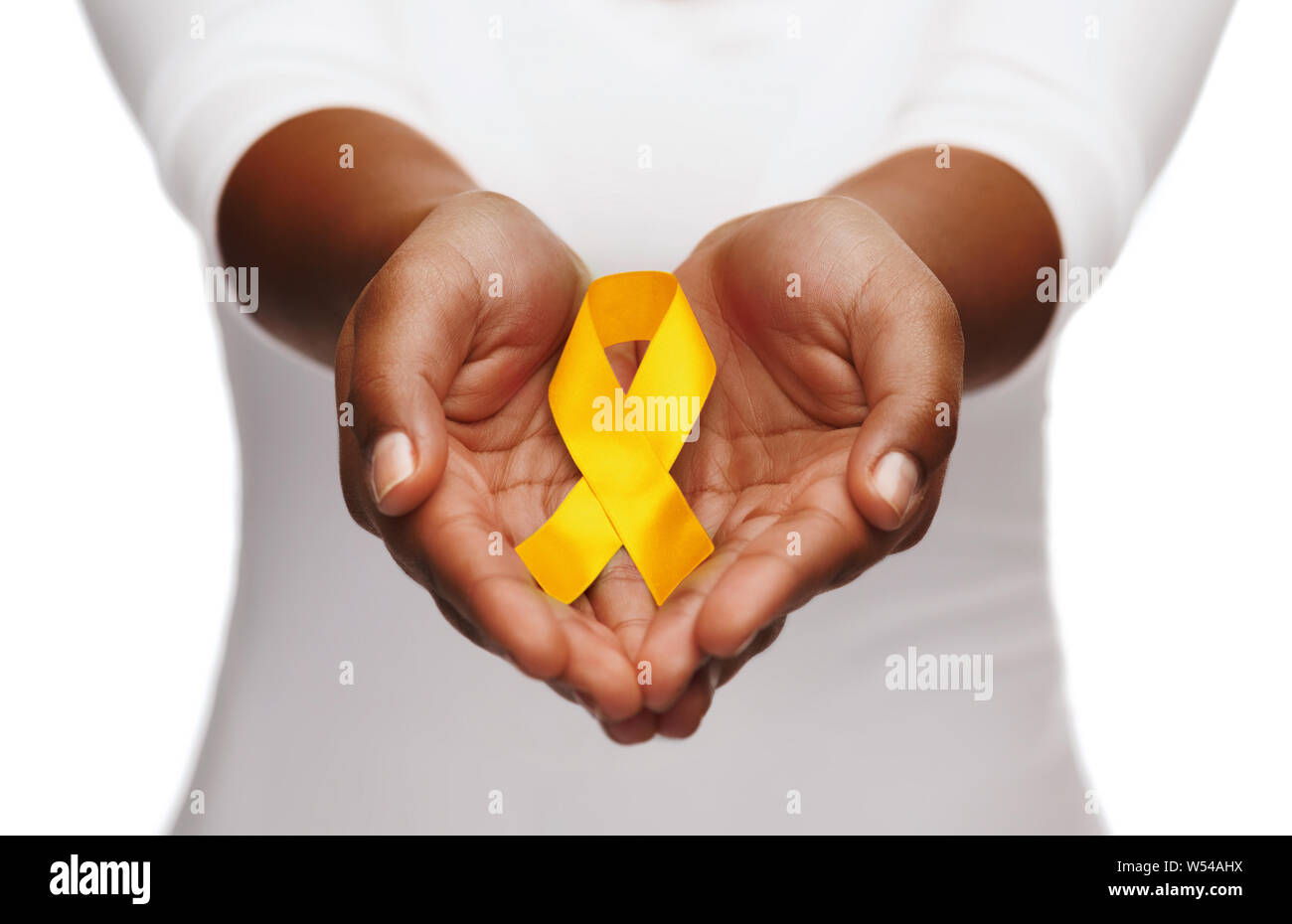 hands holding yellow gold cancer awareness ribbon Stock Photo - Alamy