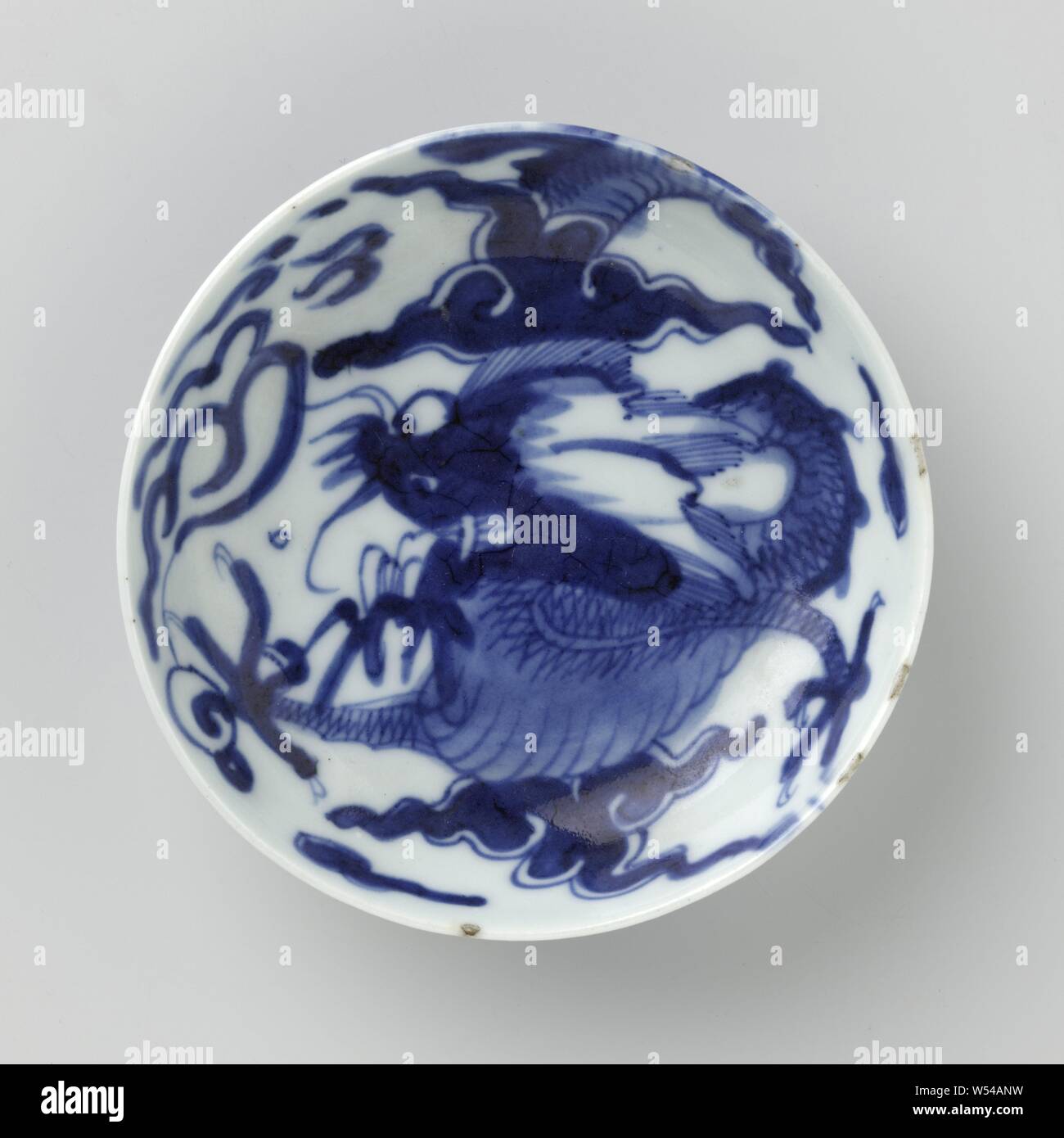 Saucer with a pearl chasing dragon, Porcelain dish with slightly ...