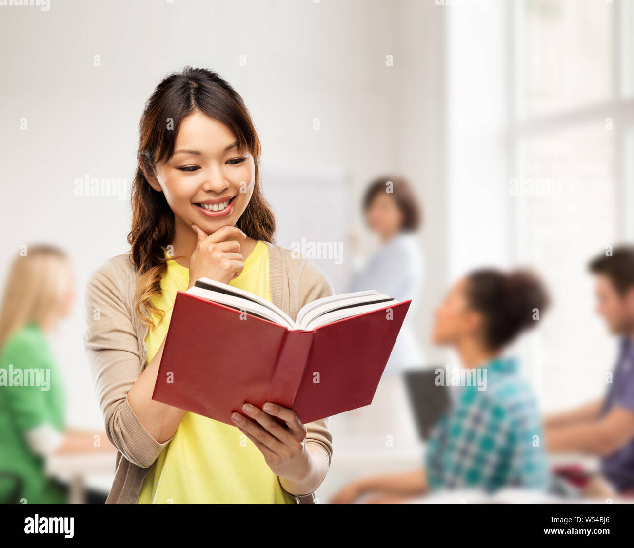 happy asian woman reading book at school Stock Photo - Alamy