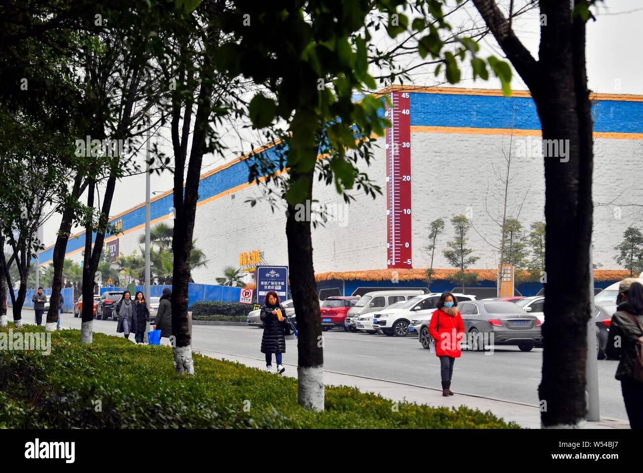Pedestrians walk past a giant thermometer showing the current outdoor ...
