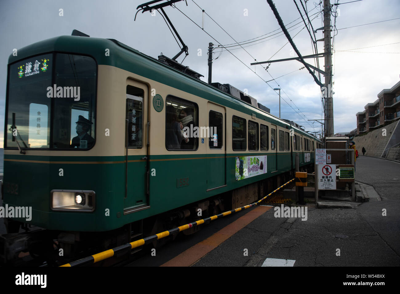A train on the Enoden Line enters the Kamakura-Koko-Mae Station by the ...