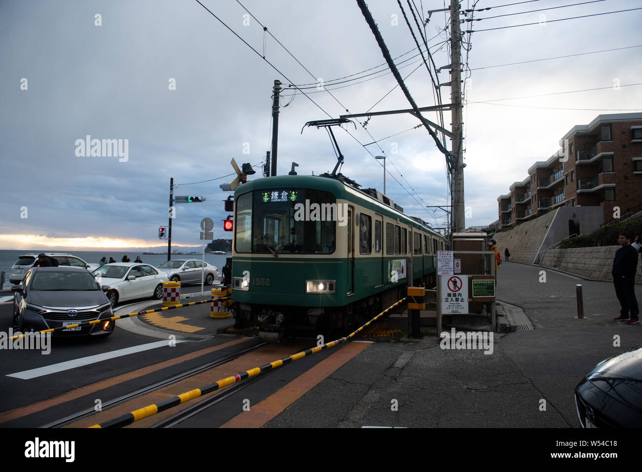 A train on the Enoden Line enters the Kamakura-Koko-Mae Station by the ...