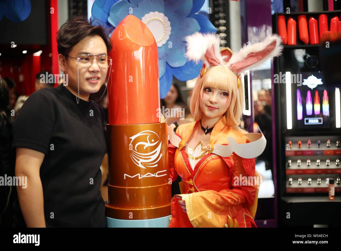 A coser dressed in costumes of Tencent's MOBA "King of Glory" poses at ...