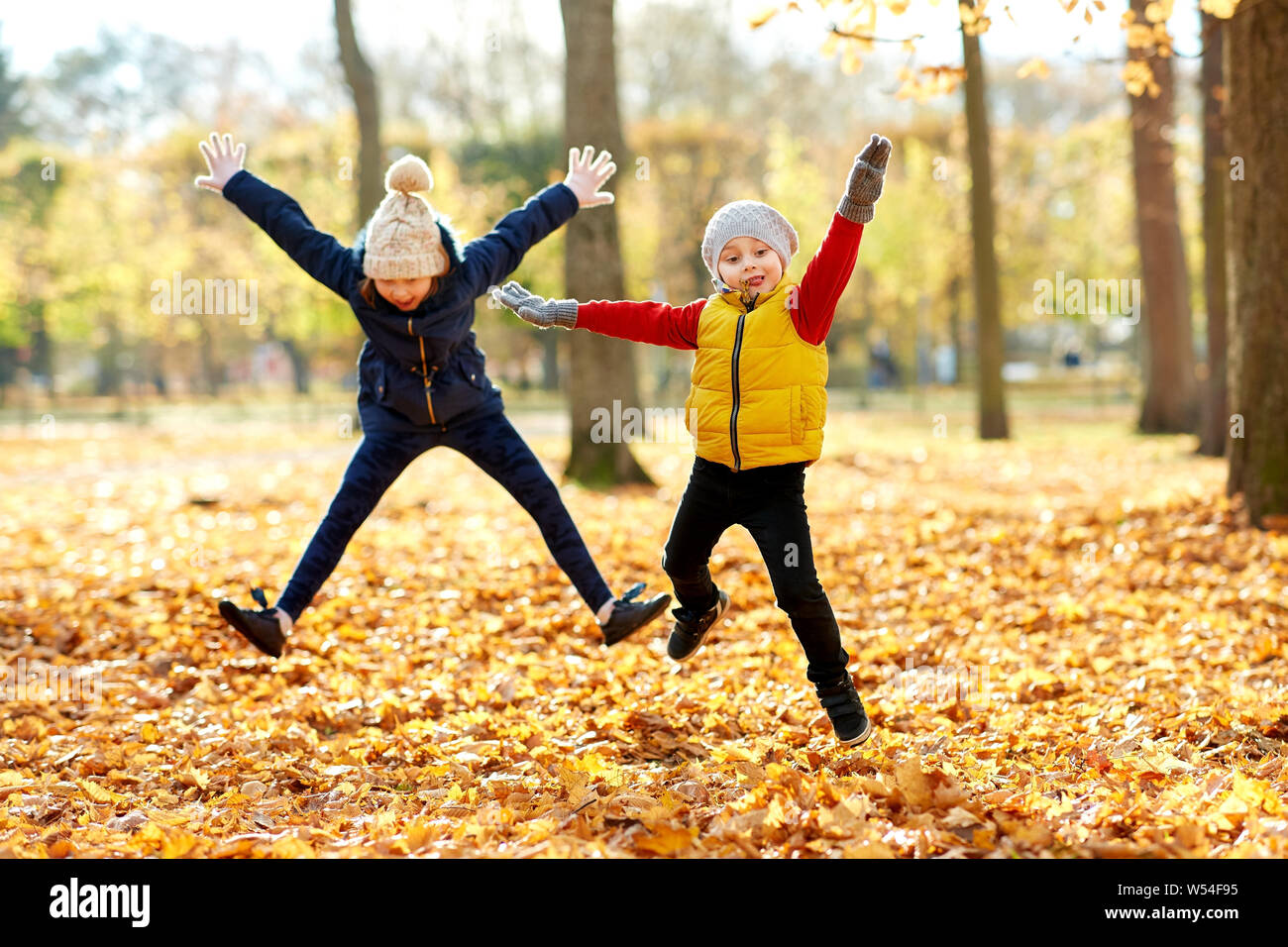 happy children running at autumn park Stock Photo - Alamy