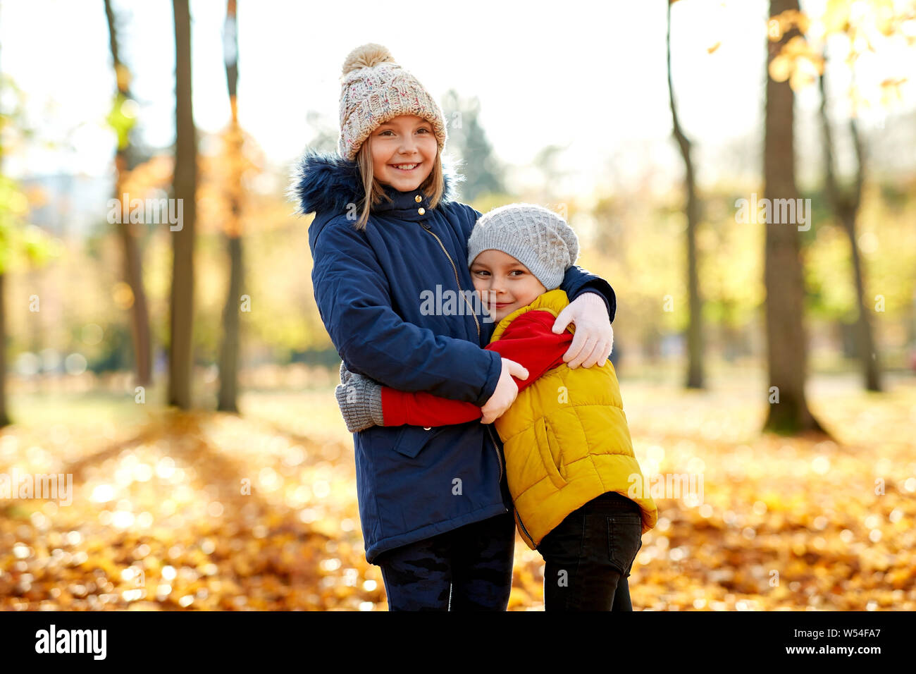 happy children hugging at autumn park Stock Photo - Alamy