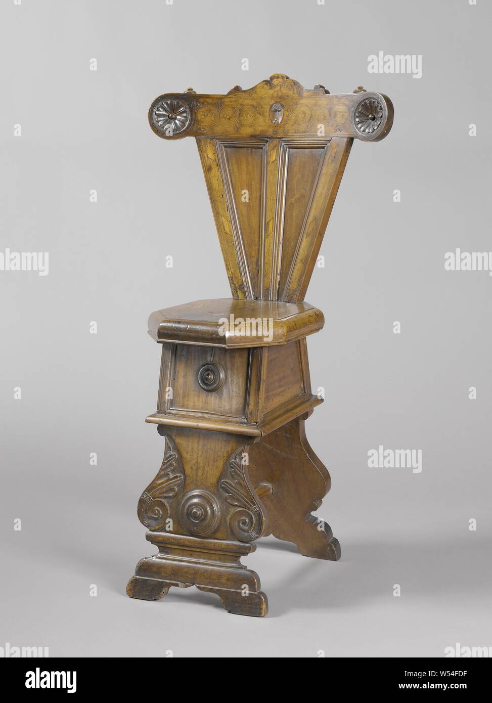 Walnut chair with octagonal seat. Tree shield and decorations in ...