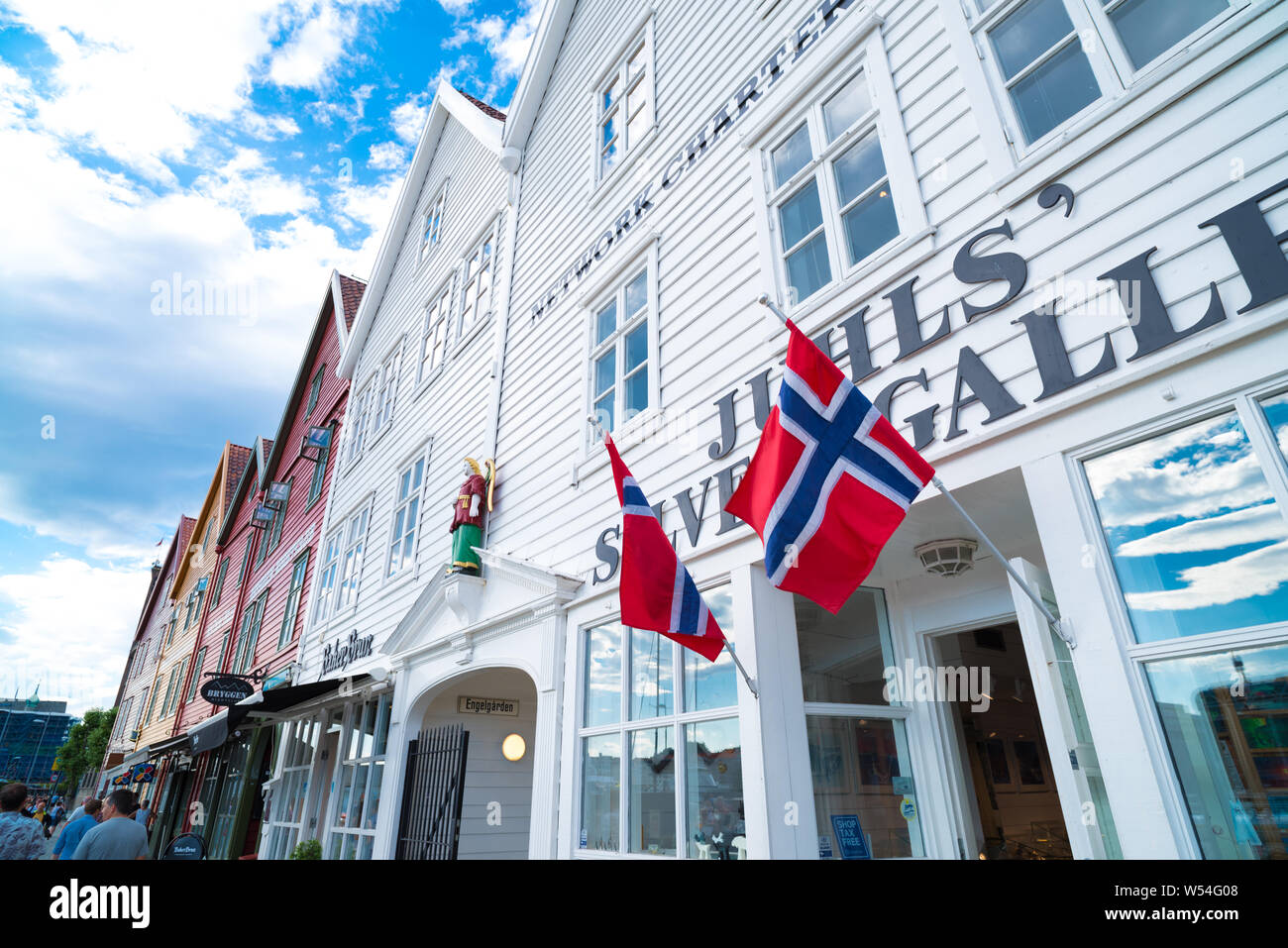 BERGEN, NORWAY - JULY 28, 2018: Norwegian flags hanging on the facade ...