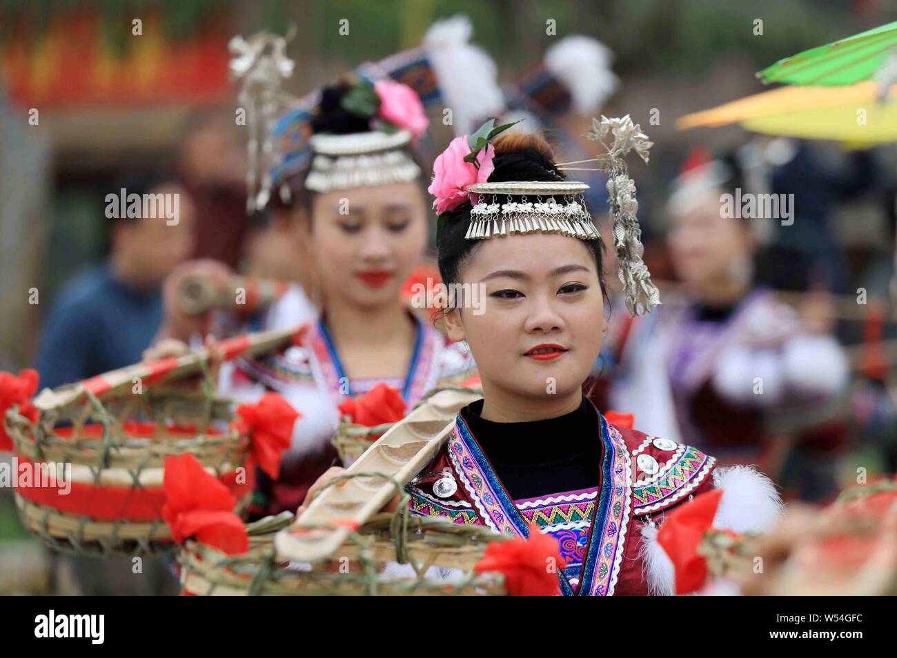 Chinese people of Miao ethnic group dressed in traditional costumes and ...