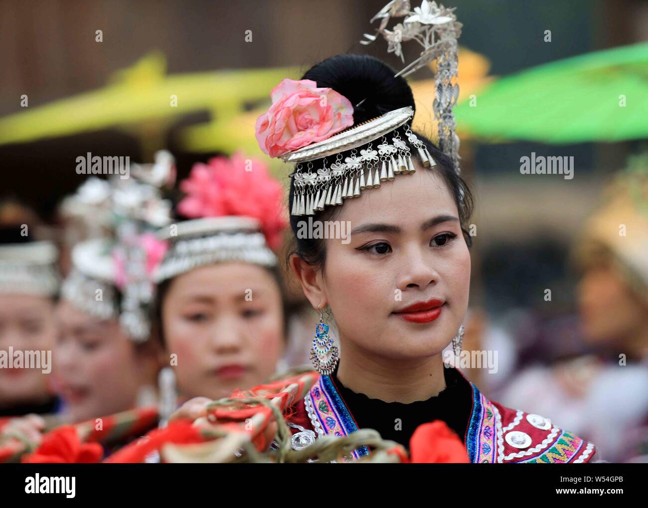 Chinese people of Miao ethnic group dressed in traditional costumes and ...