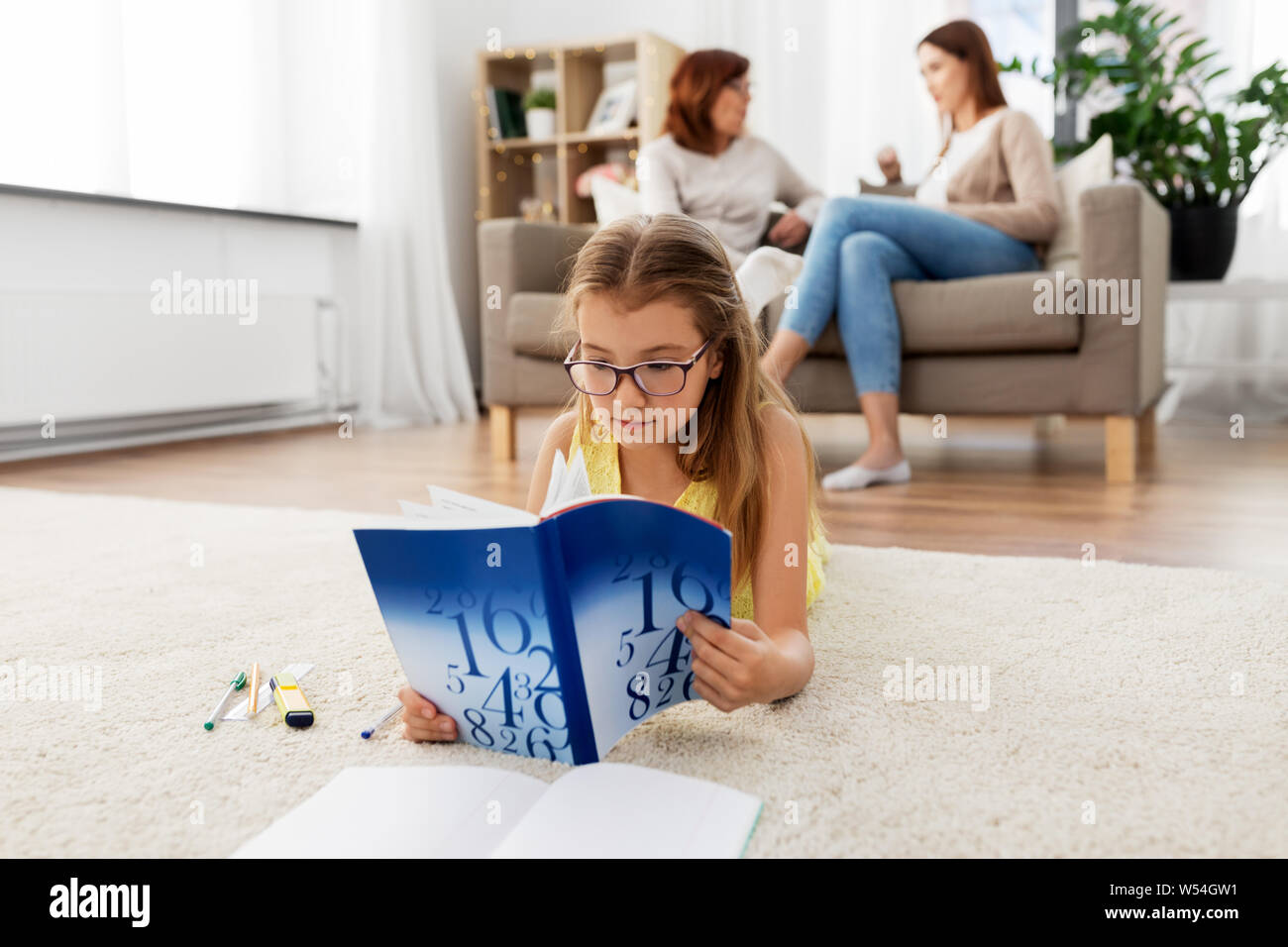 student girl with textbook learning at home Stock Photo - Alamy