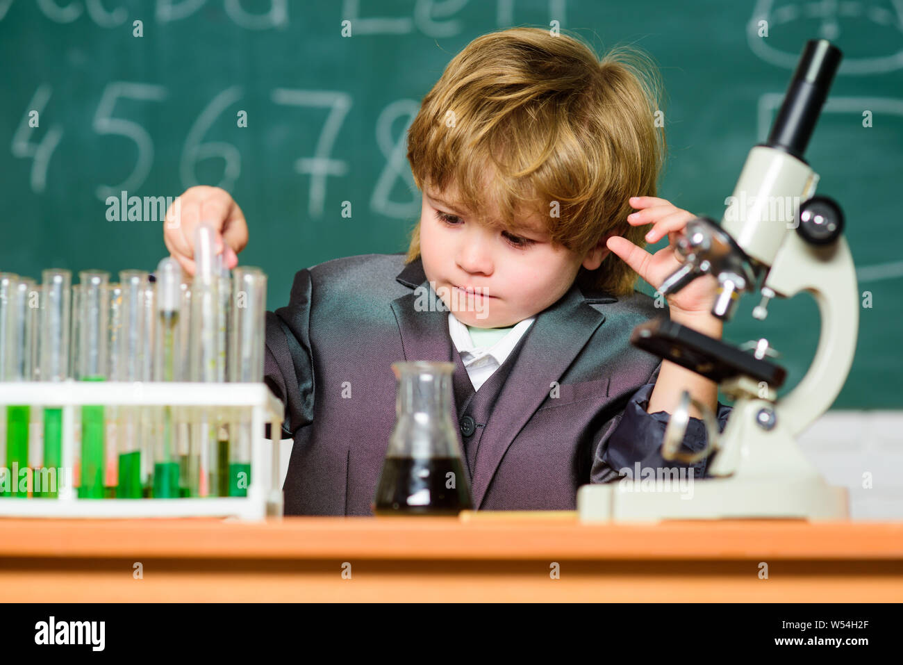 Chemical analysis. Toddler genius baby. Boy use microscope and test ...