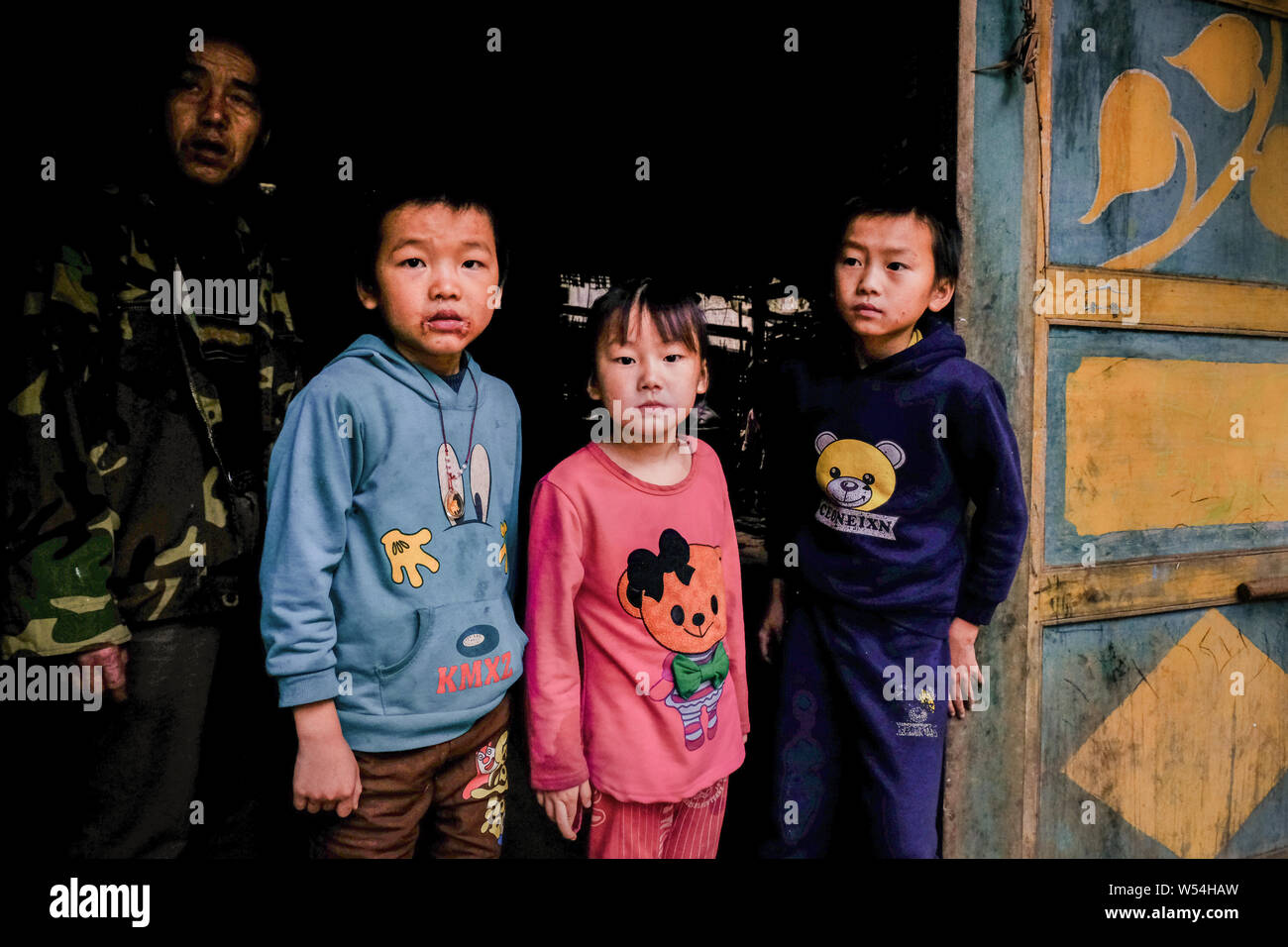 Children are seen in front of a house in Nongli village, Bansheng town ...