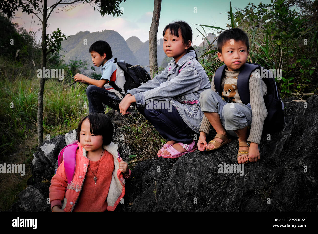 Children climb the mountains in Nongli village, Bansheng town, Dahua ...