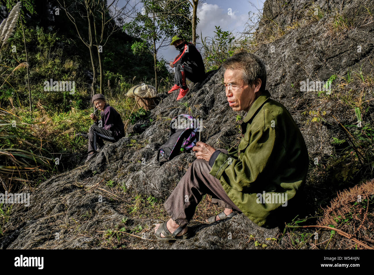 Local residents climb the mountains in Nongli village, Bansheng town ...