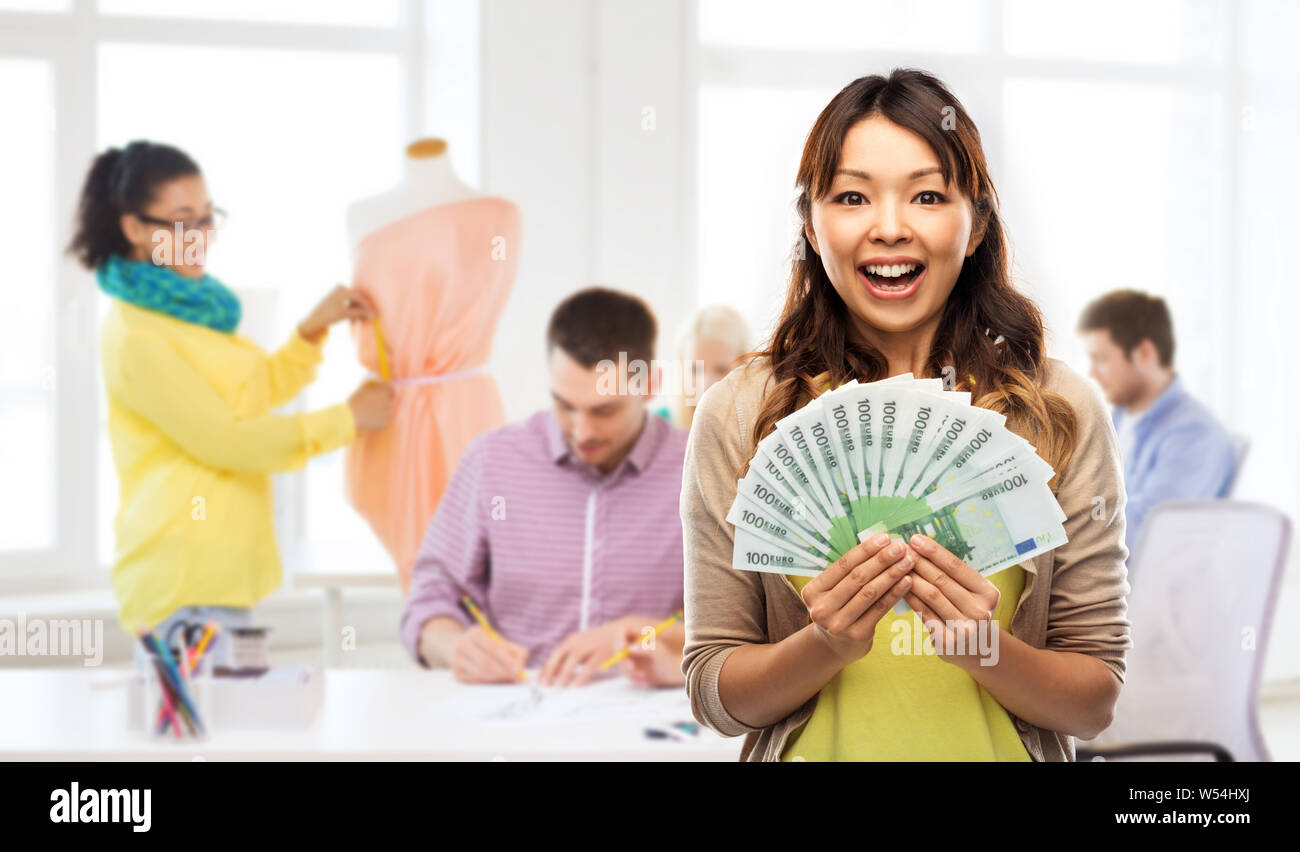 asian woman with money over fashion design studio Stock Photo - Alamy