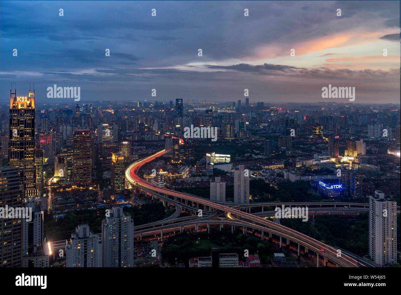 A night view of elevated highways through clusters of high-rise ...