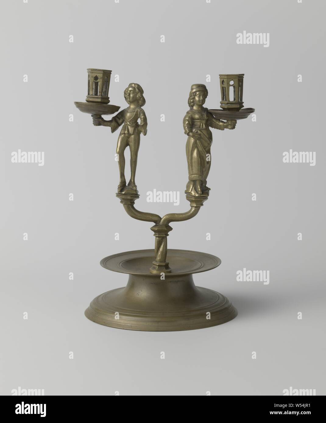 Two-armed candlestick with a male and female figure, The candlestick is ...