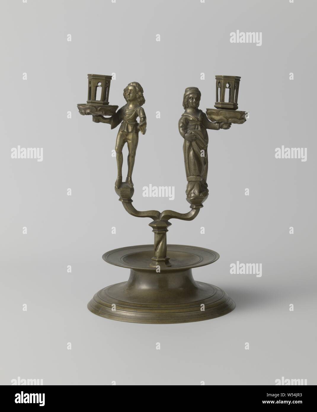 Two-armed candlestick with a male and female figure, The candlestick is ...