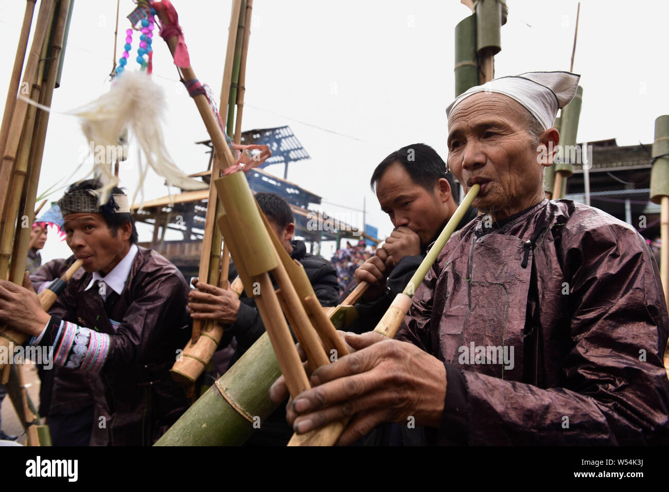 Chinese people of Miao ethnic minority dressed in traditional clothes perform Lusheng to ...