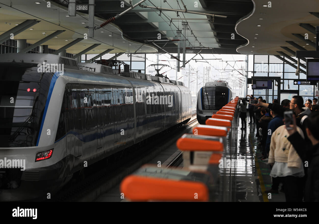 Passengers take a railway train of the city railway S1 line, based on ...