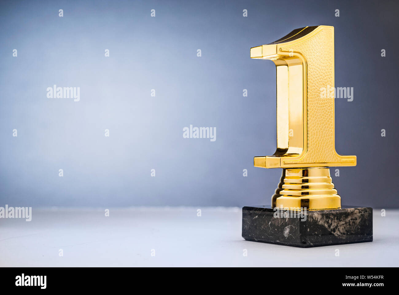 Winners 1st place gold trophy with copy space placed to the side over ...