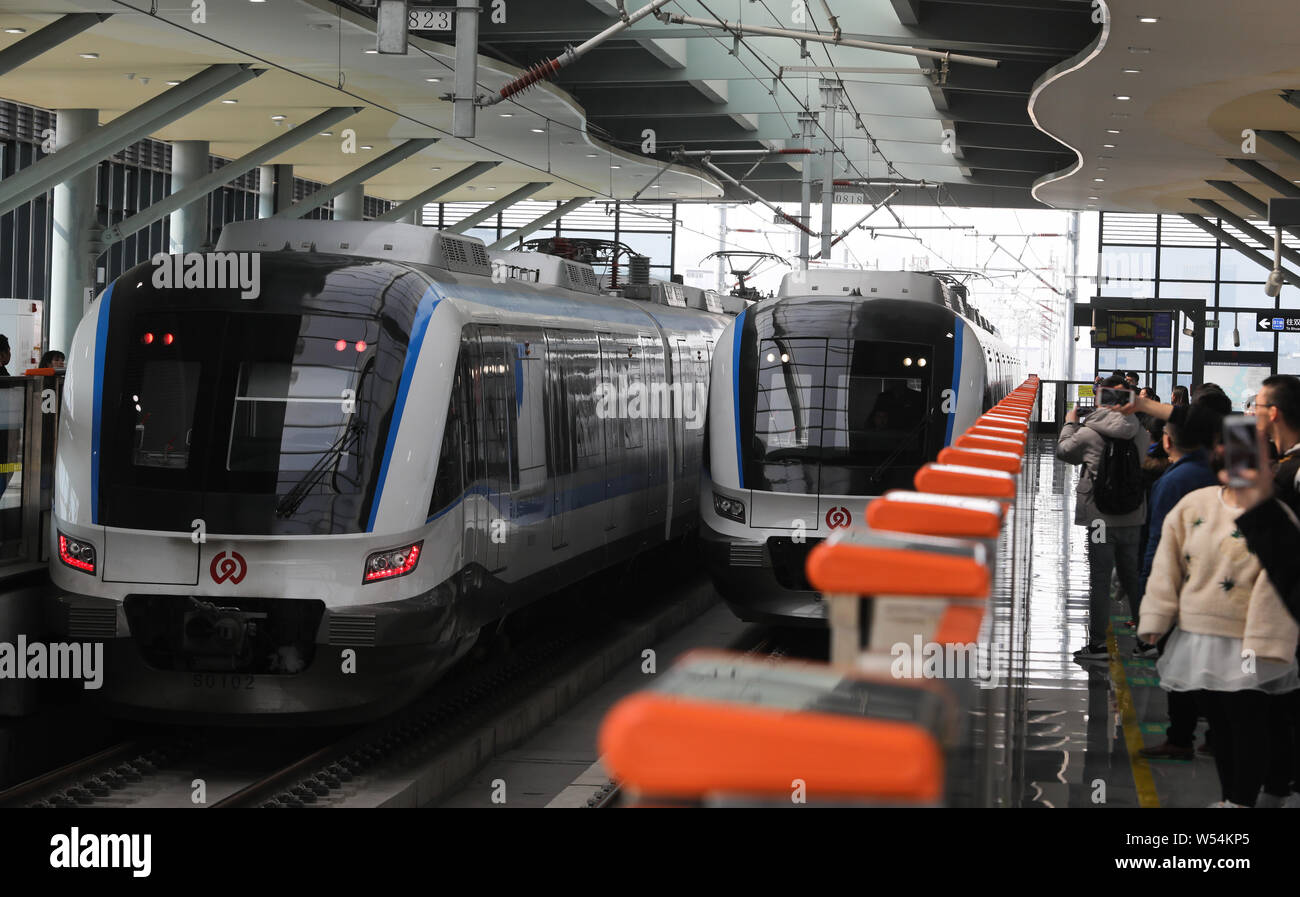 Passengers take a railway train of the city railway S1 line, based on ...